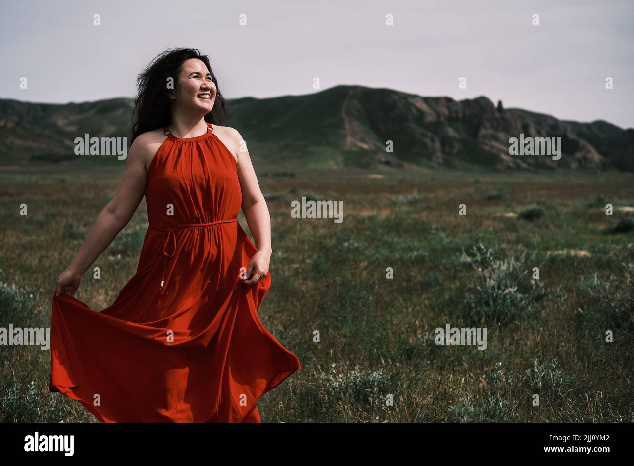 Girl in red dress walking hi-res stock photography and images - Alamy