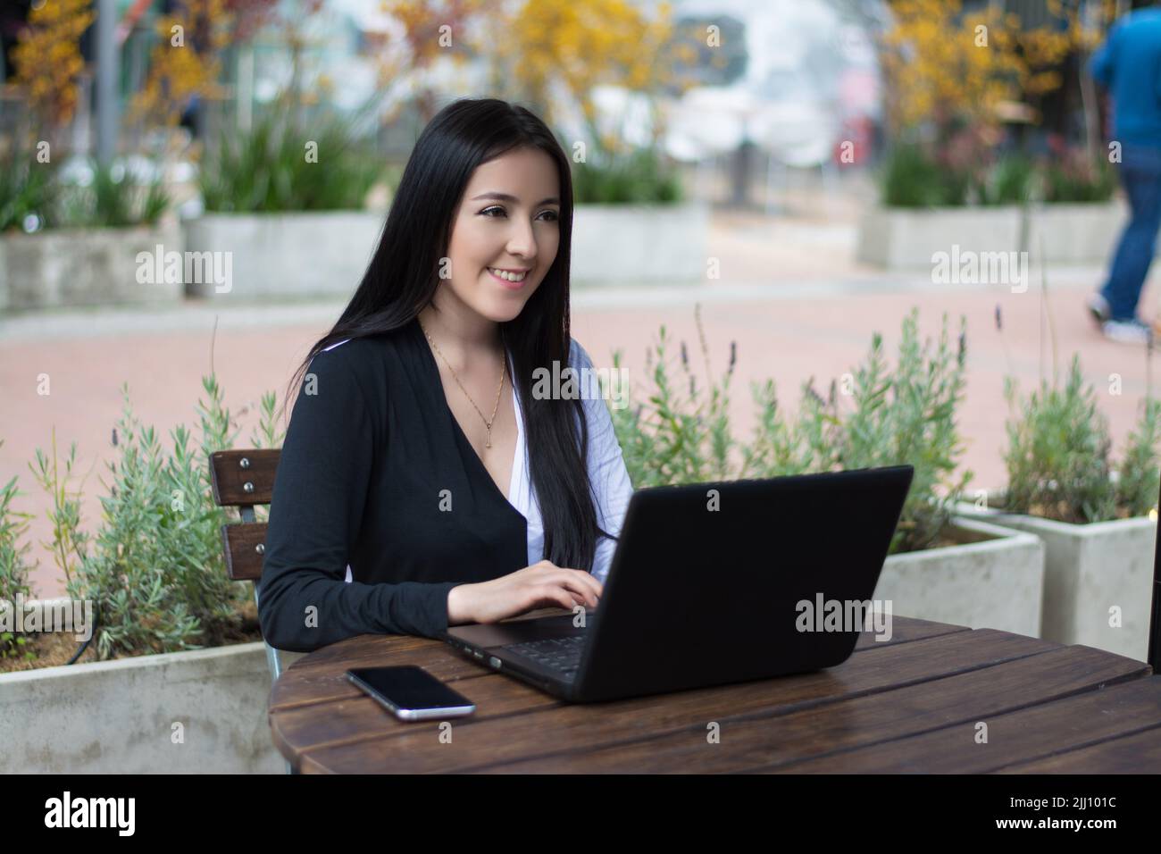 woman working on laptop in a cafe. Business woman working outdoor Stock ...