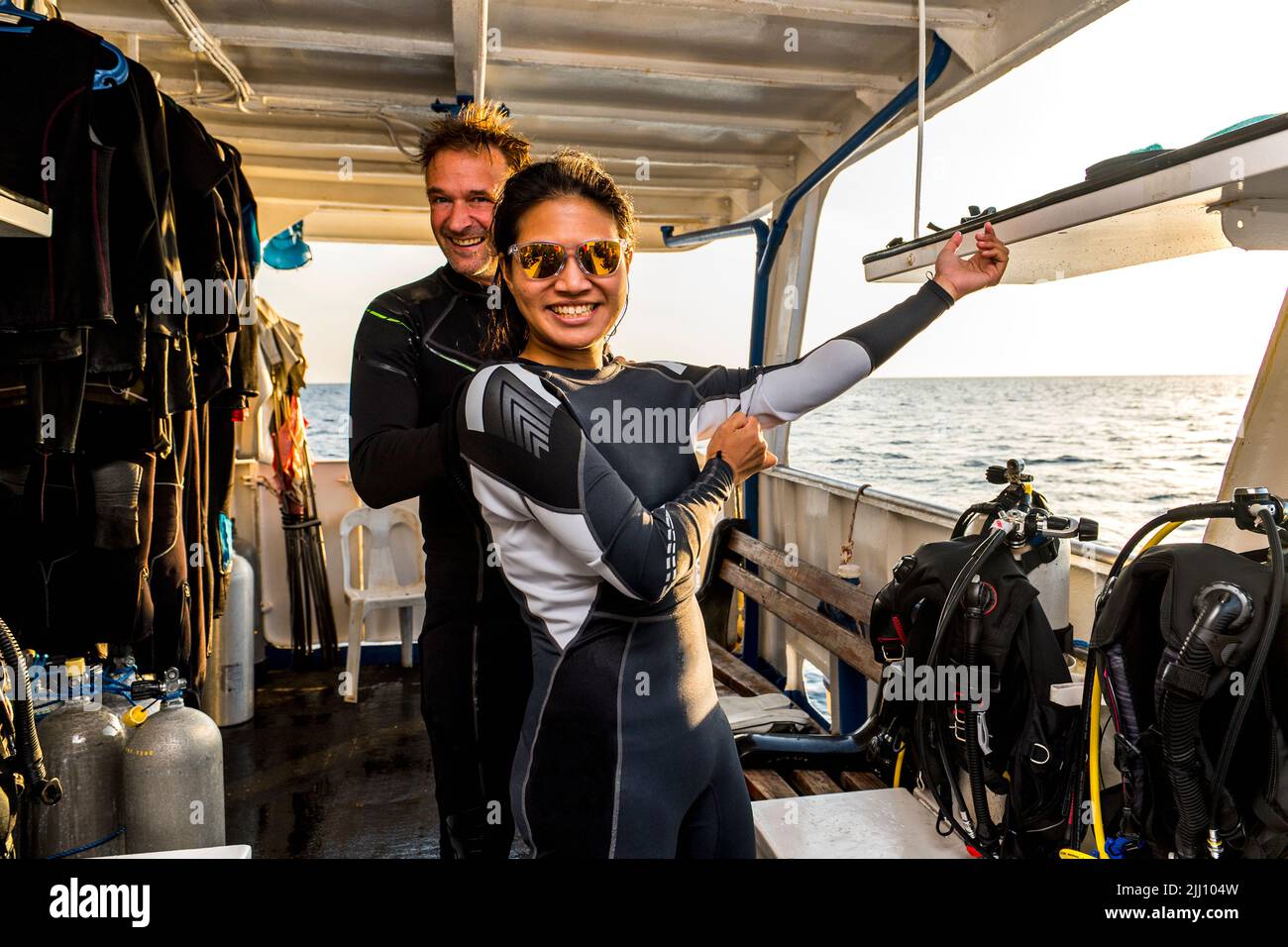 couple getting ready for a dive on a research vessel at Tubbataha reef ...