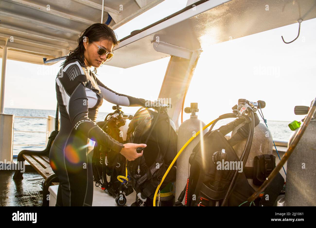 woman getting ready for a dive on a research vessel at Tubbataha reef ...