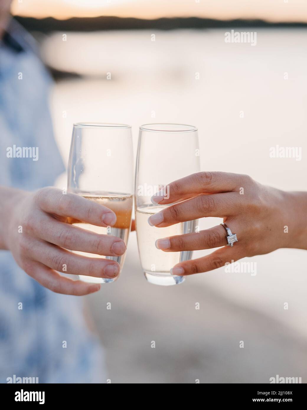 Engaged Couple Celebrating their Engagement with Champagne Toast Stock ...