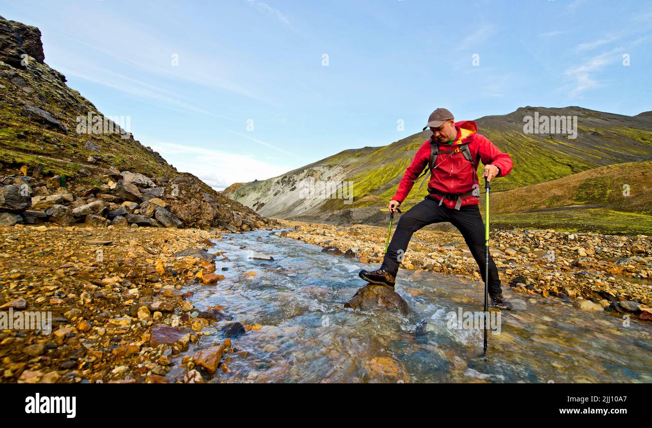 man jumping over river in Landmannalaugar / Iceland Stock Photo - Alamy