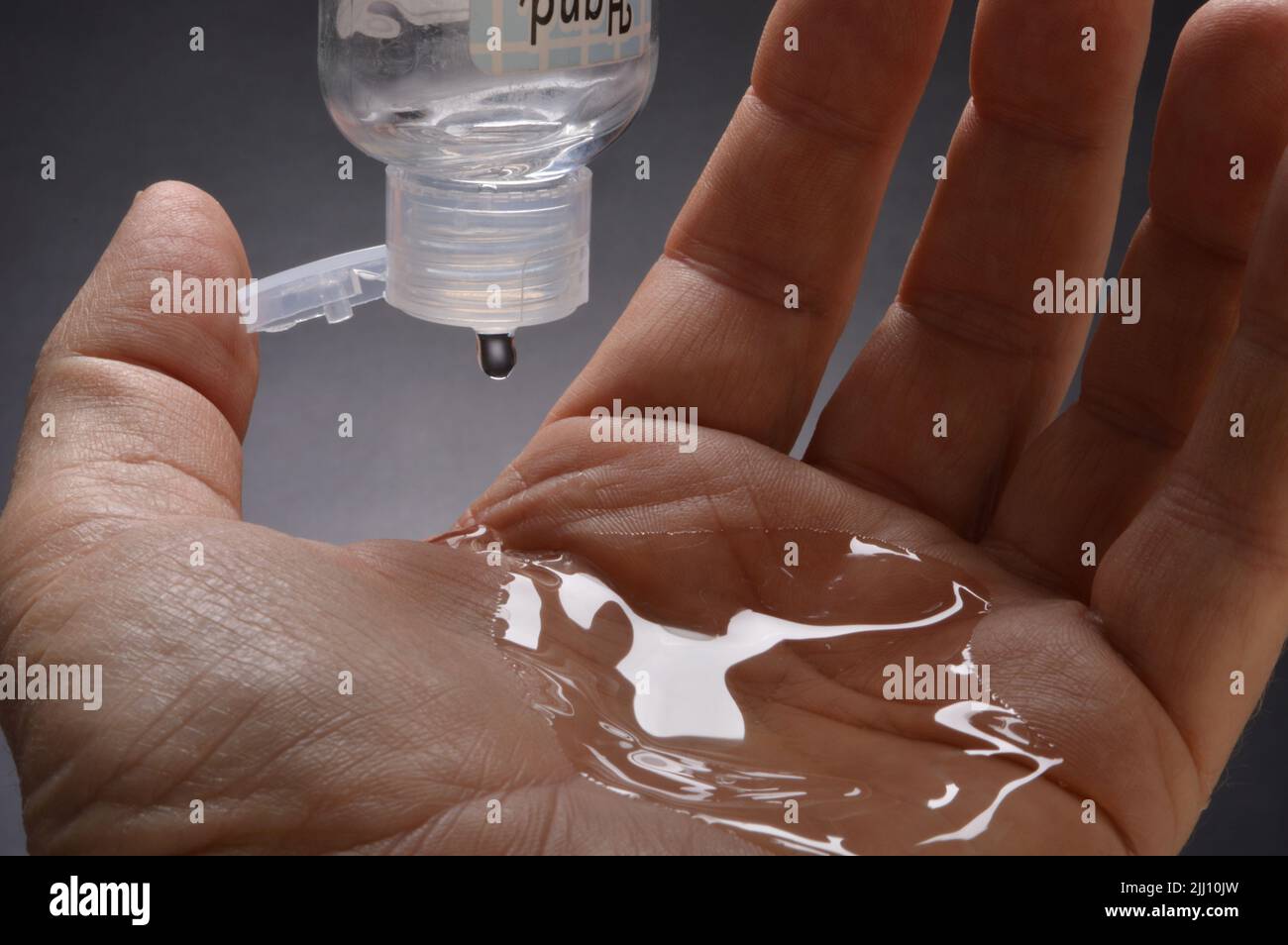 Hand sanitizer dripping into and overflowing from hand Stock Photo - Alamy