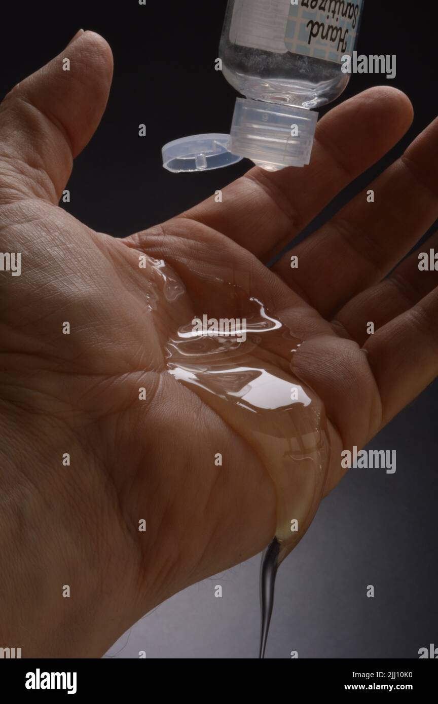 Hand sanitizer dripping into and overflowing from hand Stock Photo - Alamy