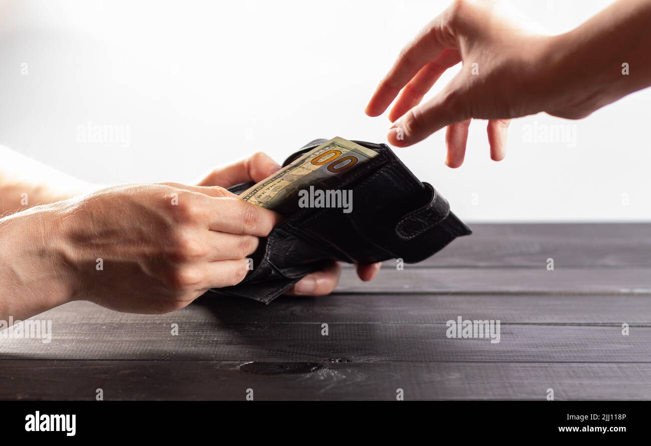 hand of teenager asking his father for money. Man count money cash in ...