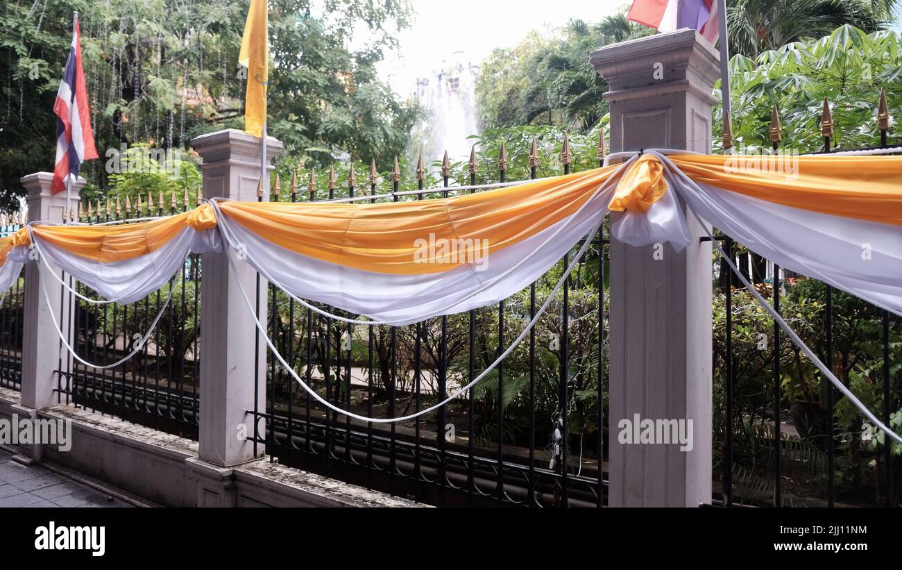 Orange and White Silk Banner on the fence of a Thai Buddhist Temple Wat ...