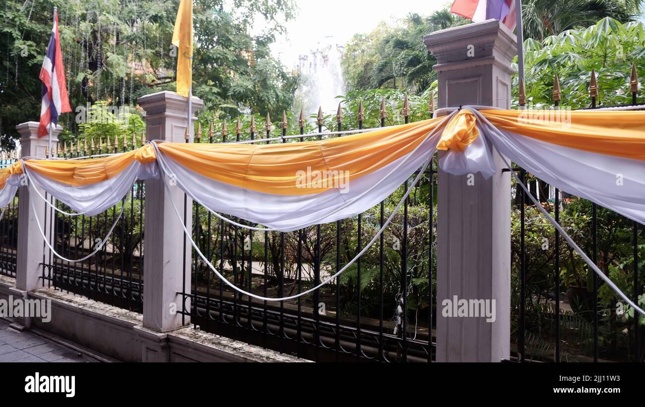 Orange and White Silk Banner on the fence of a Thai Buddhist Temple Wat ...