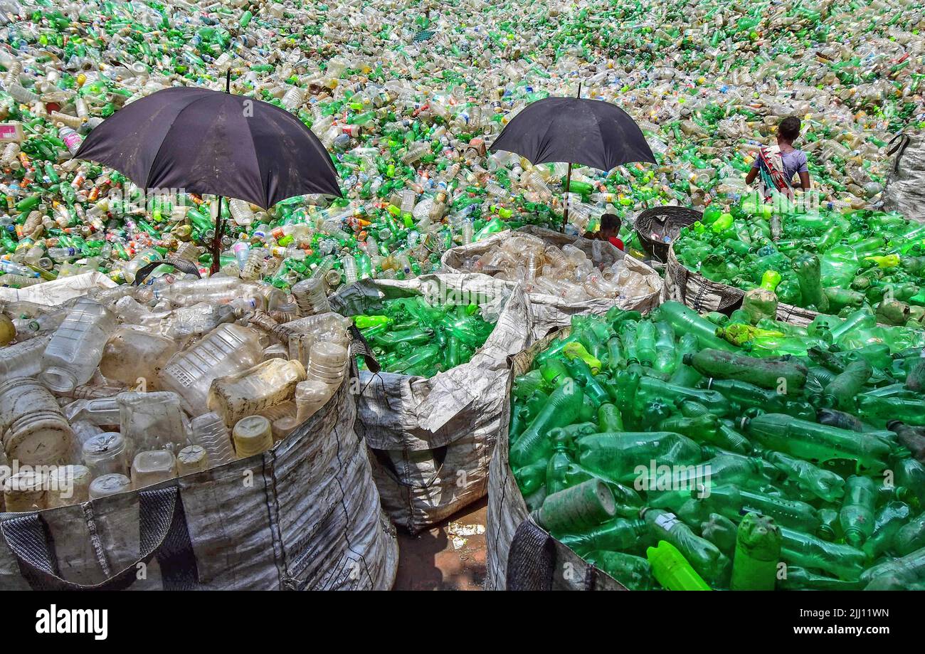 Workers sorting plastic bottles by hand in a recycling plant, Bogura ...