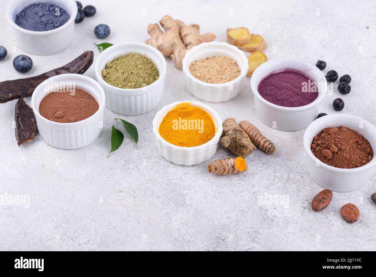 Various healthy superfoods powder in bowls Stock Photo - Alamy