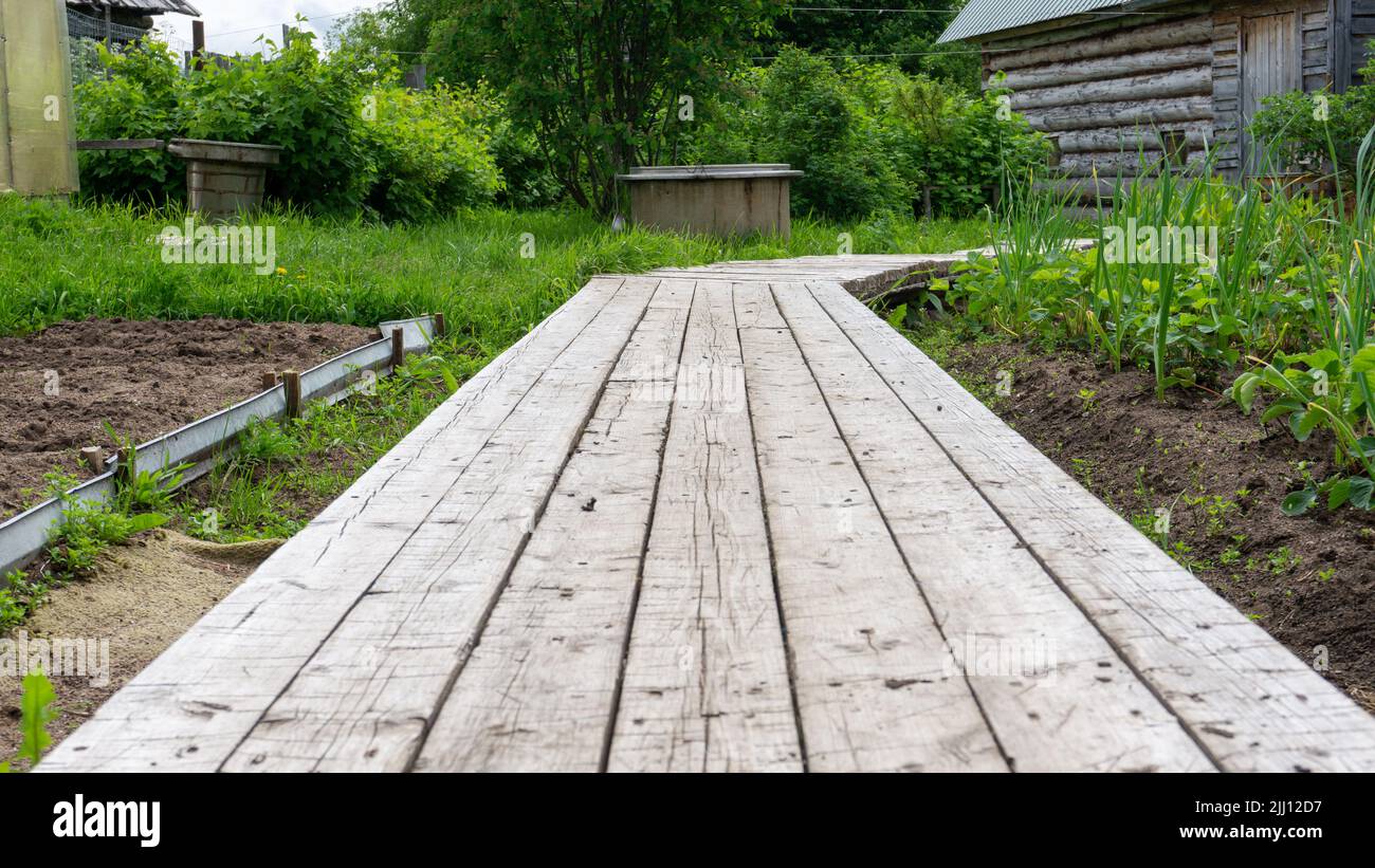Wooden footbridge near a village house in Russia. Close up photo below ...