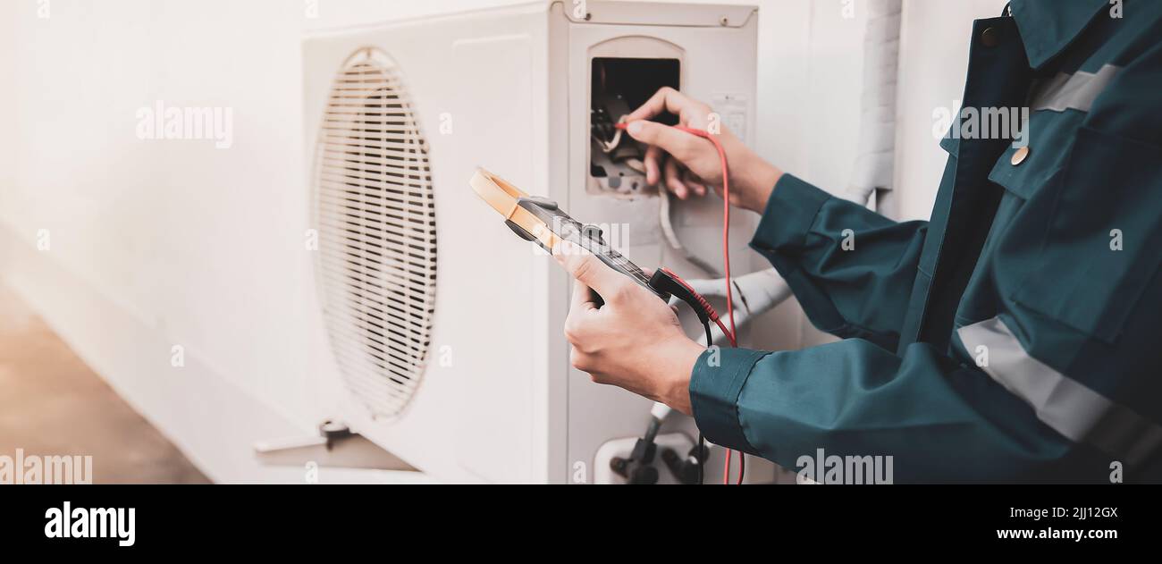 Technician checking the operation of the air conditioner Stock Photo ...