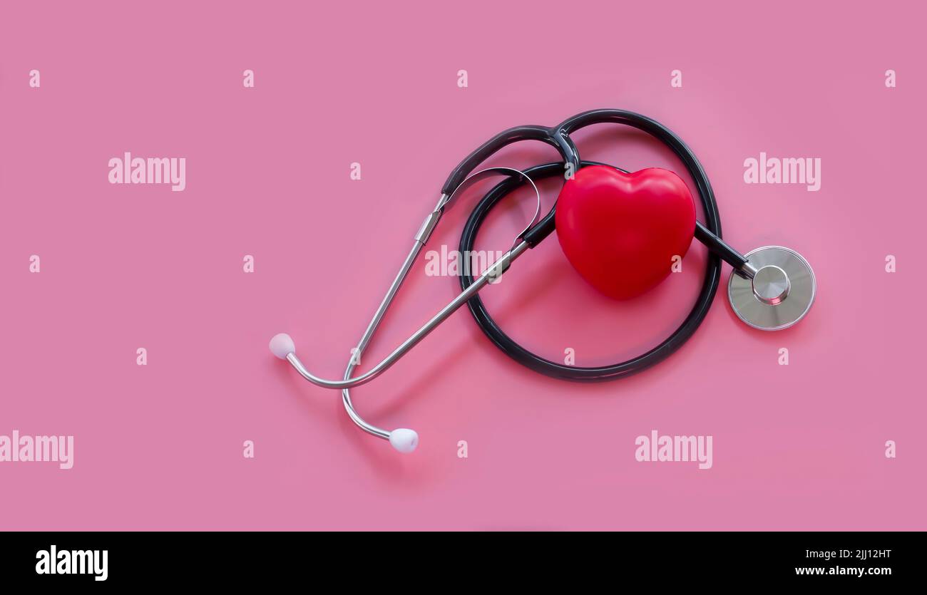 Stethoscope and red hearts on a pink background, Health care concept ...