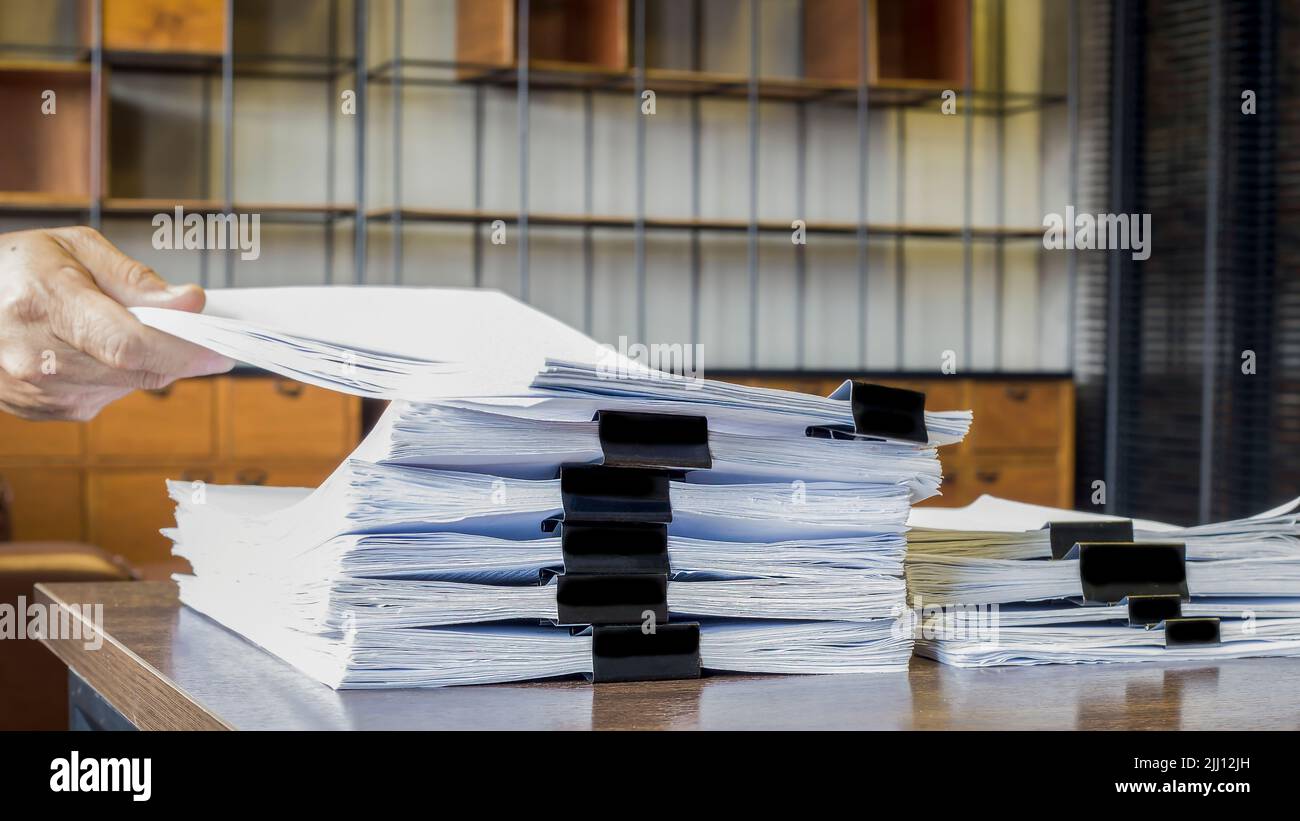 Document, Paper, File.Piles of papers placed on a dark wooden table ...