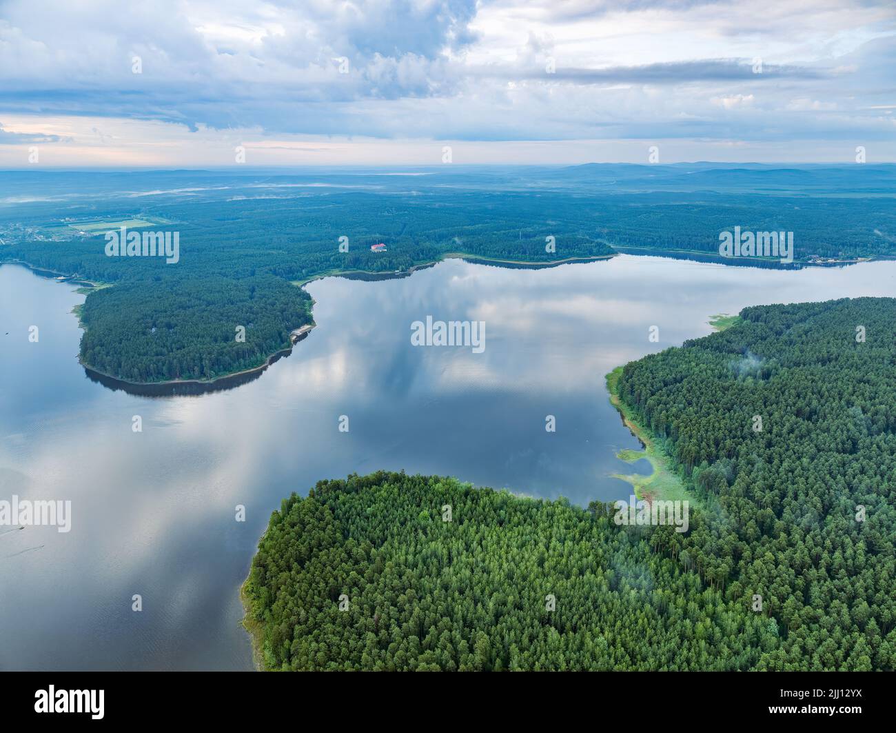 Big lake with green shores in bright sun light, aerial landscape ...