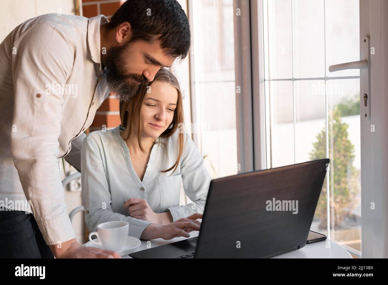 Happy couple hugging desk hi-res stock photography and images - Alamy