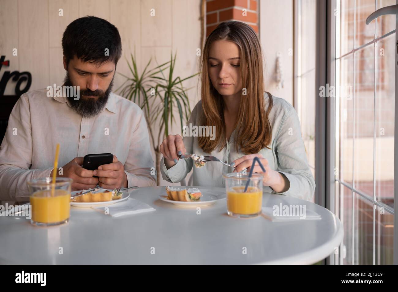 Using phone while eating family hi-res stock photography and images - Alamy