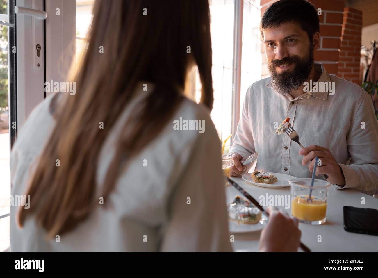 Happy loving couple enjoying breakfast in a cafe. Love, dating, food ...
