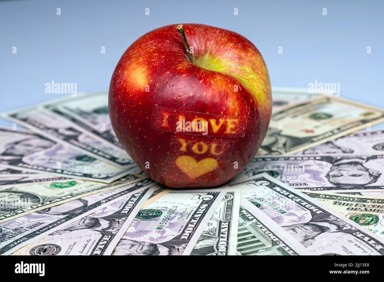 I love You apple with heart on dollar banknotes. The concept of love ...