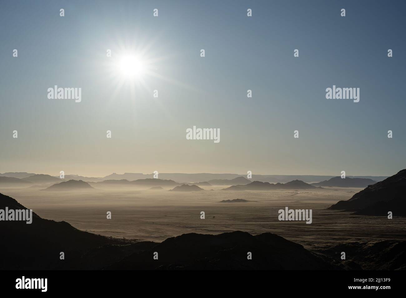 Silhouettes of hills and mountains in the Namib Desert in Namibia. The ...