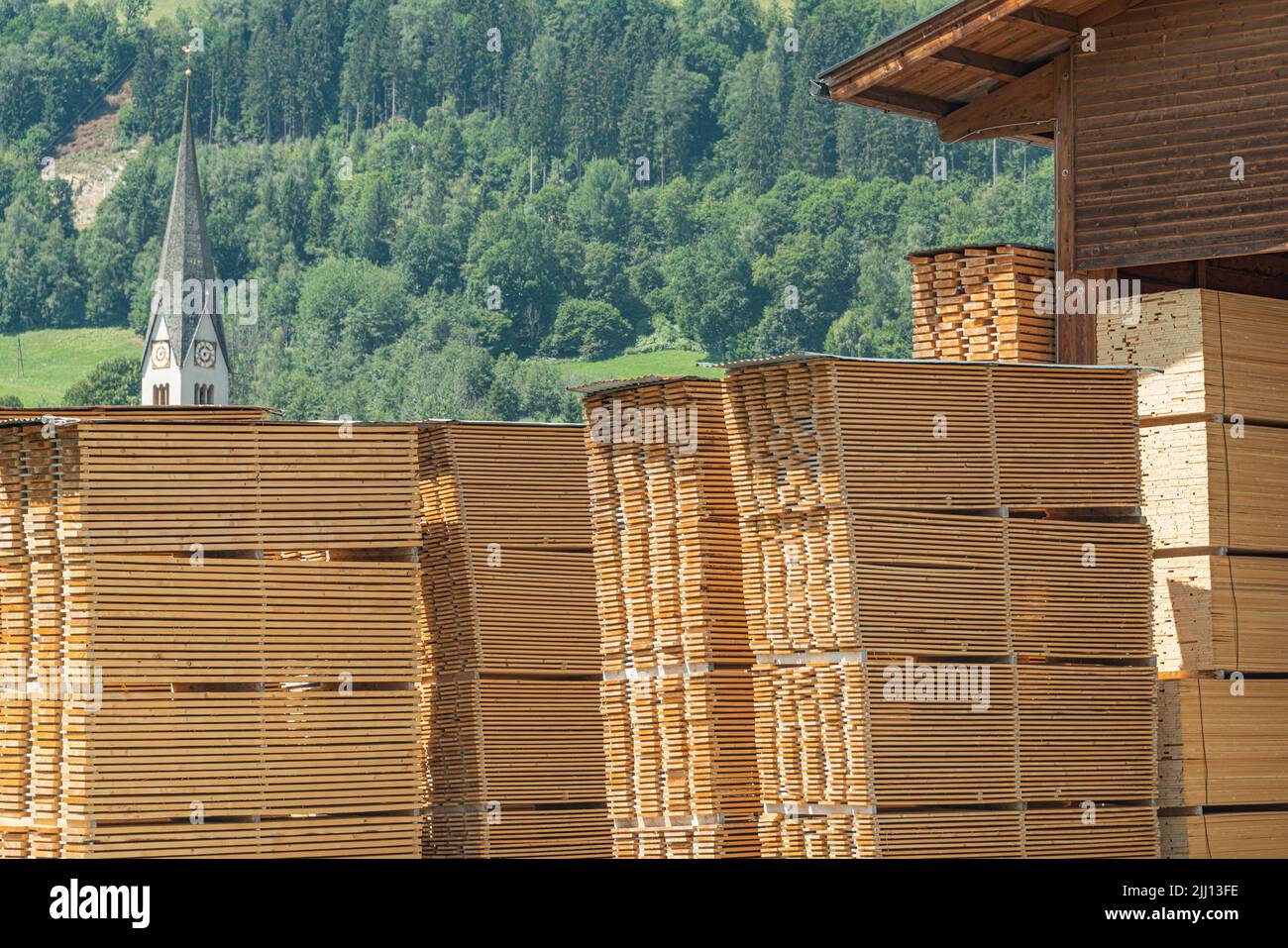Lots of planks stacked on top of each other in the warehouse. Lumber ...