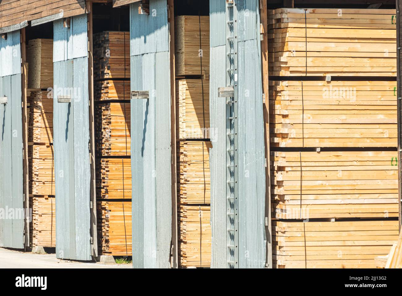 Lots of planks stacked on top of each other in the warehouse. Lumber ...