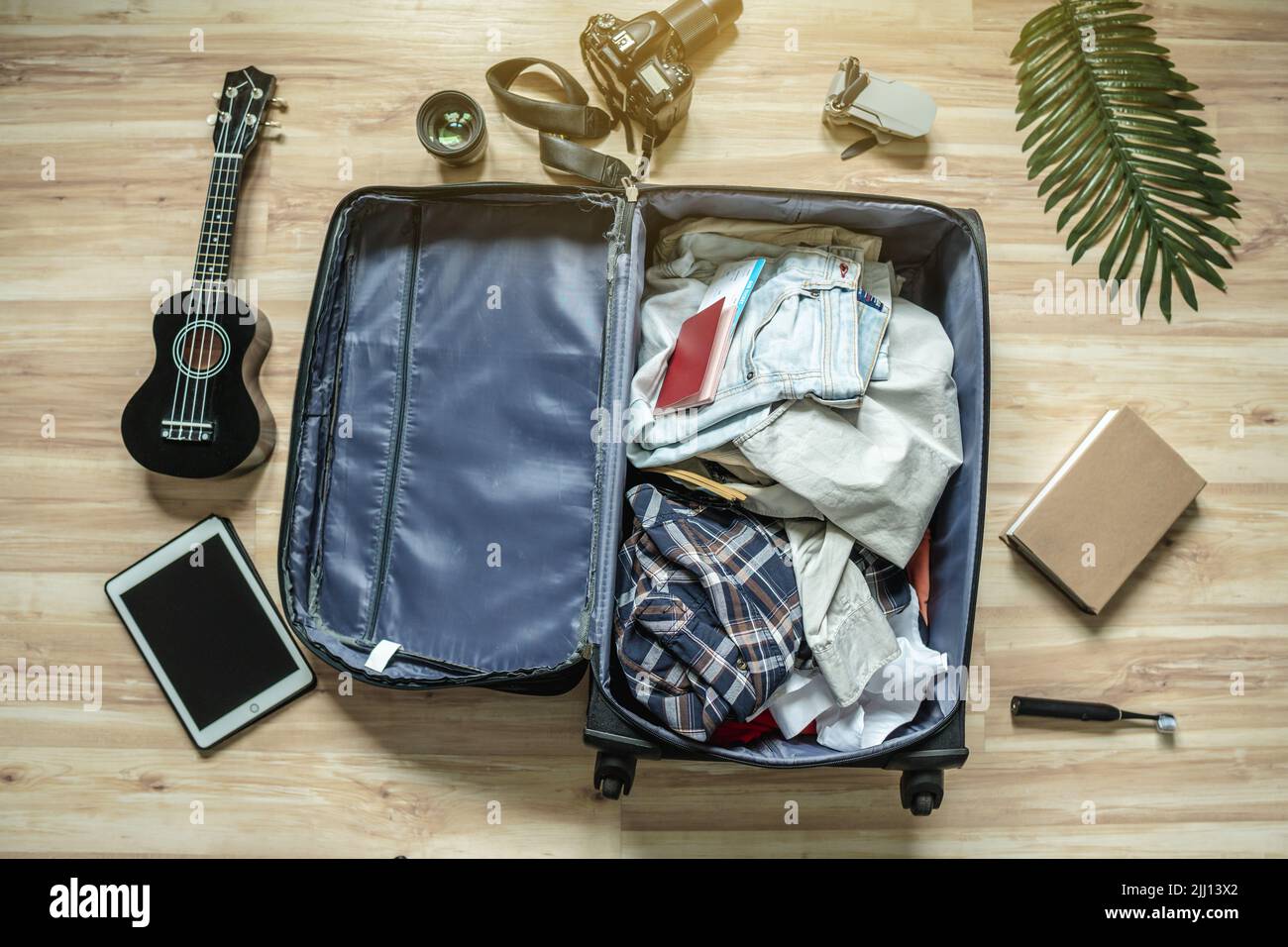 Packing a suitcase for a summer vacation. Preparation of things and ...