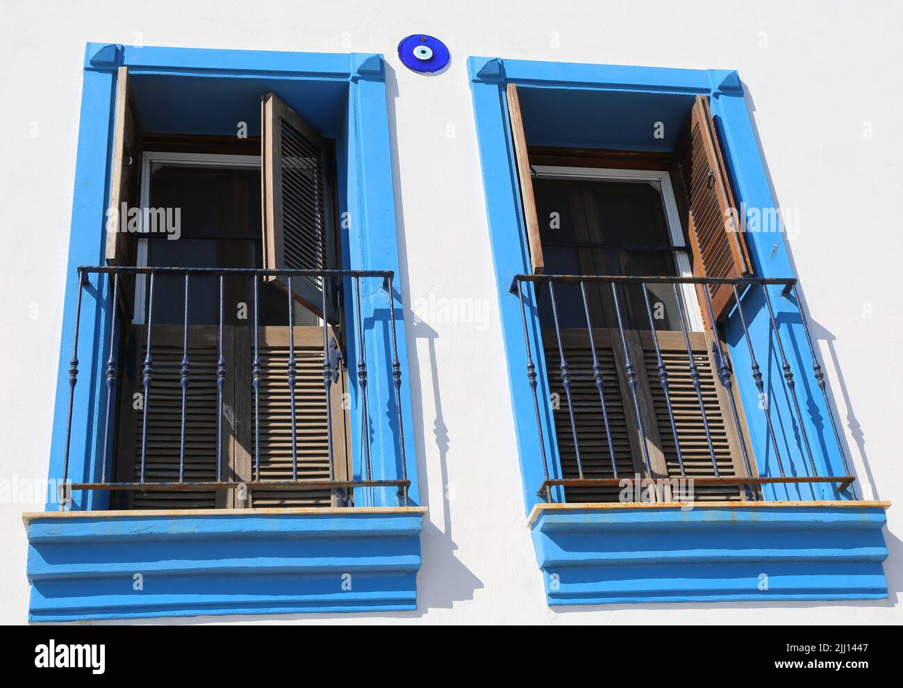 Windows with Brown Shutters and blue frames Stock Photo - Alamy