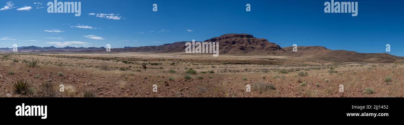 A panoramic photo of a hill/mountain in the middle of Namibia. Blue sky ...