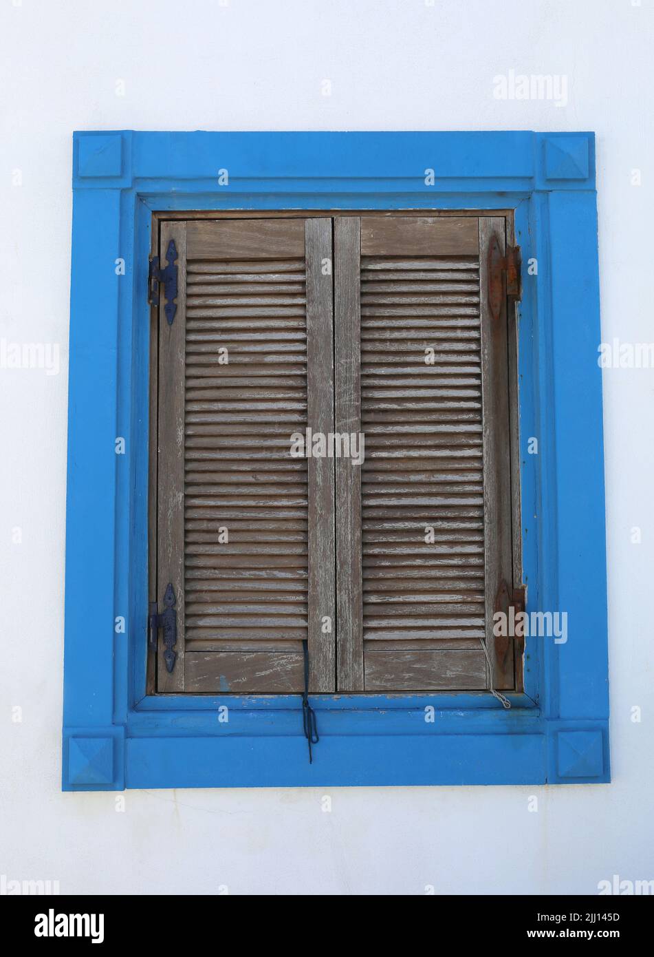 Window of the old Greek Home with Brown Window shutters and Blue Frames ...