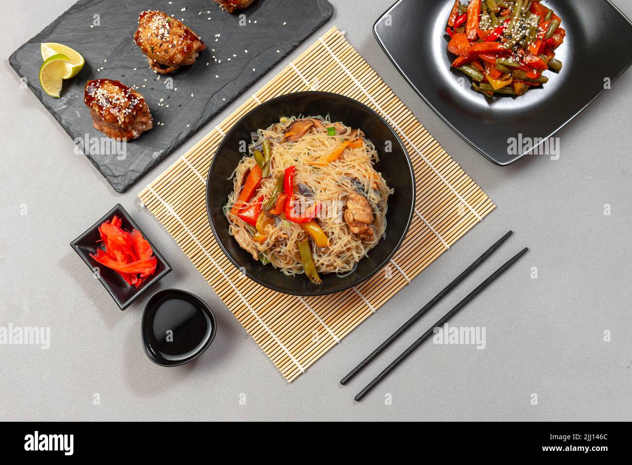 A mix of Asian food on a gray background. Delicious Chinese and Thai ...