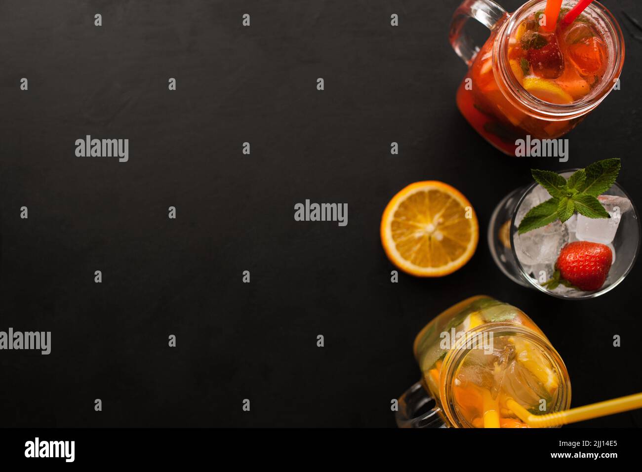 Top view fresh cocktails on black background Stock Photo - Alamy
