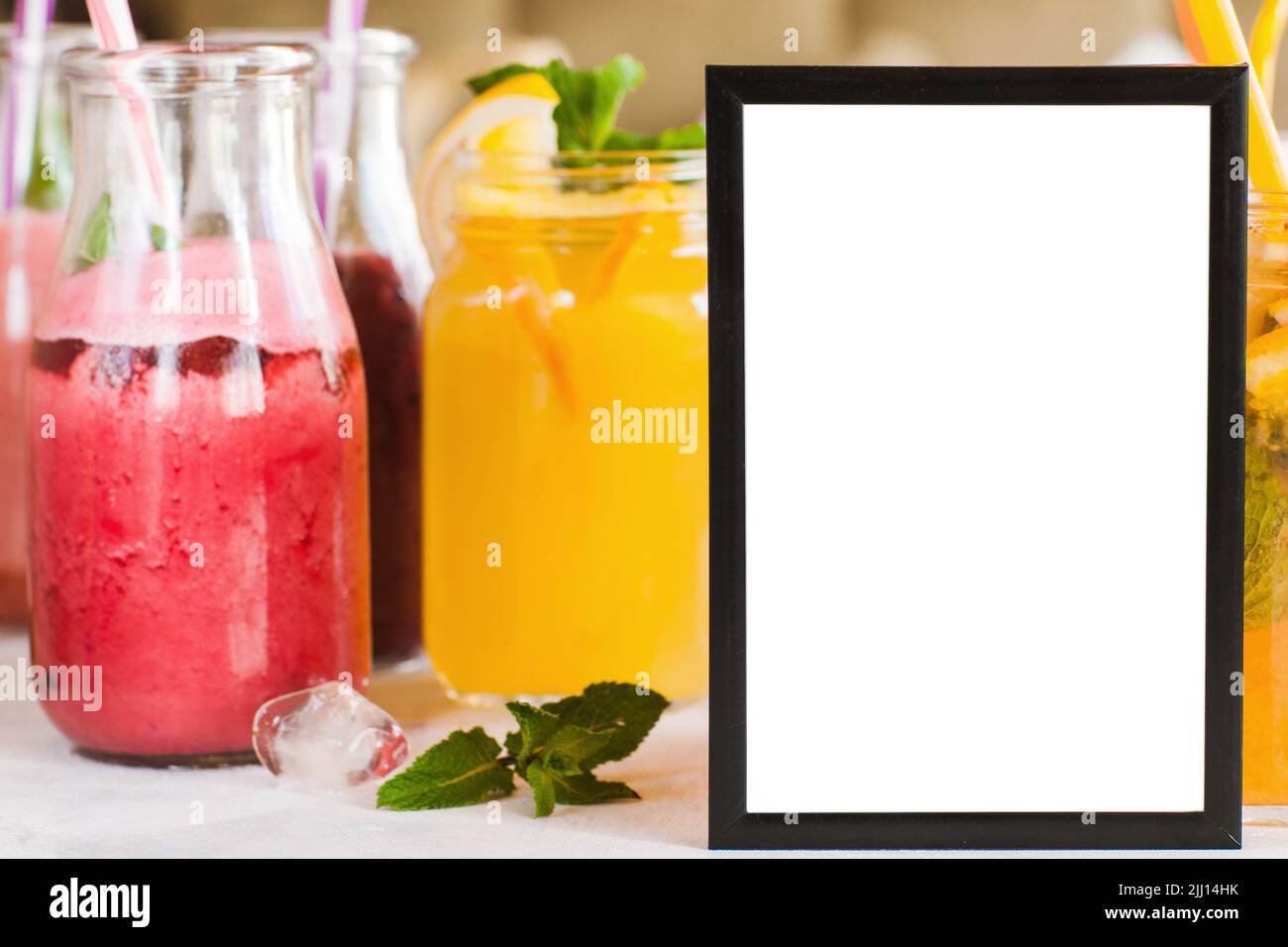 Blank picture frame with fresh fruit drinks behind Stock Photo - Alamy