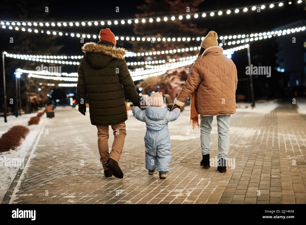 Horizontal back view shot of stylish man and woman spending winter ...