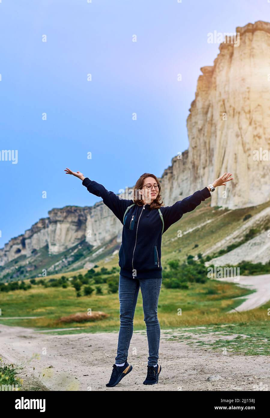 girl stands at the foot of the mountain Stock Photo - Alamy