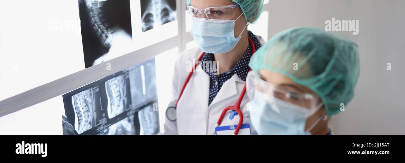 Women professional doctors look through x ray scans in hospital ...