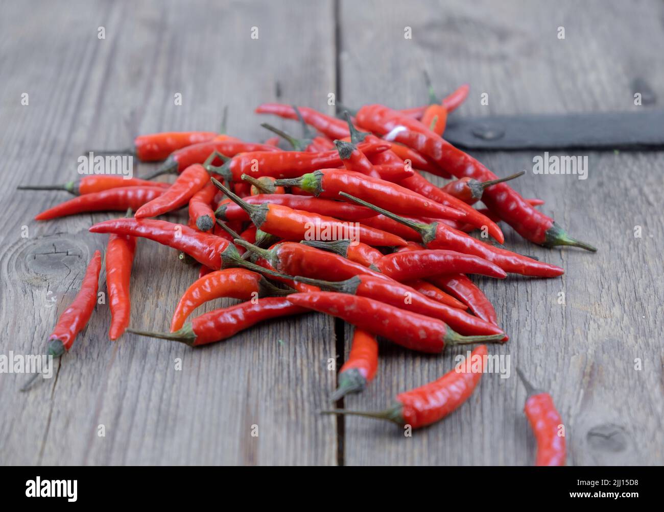 Close up fresh red hot chilli on wooden table background Stock Photo ...
