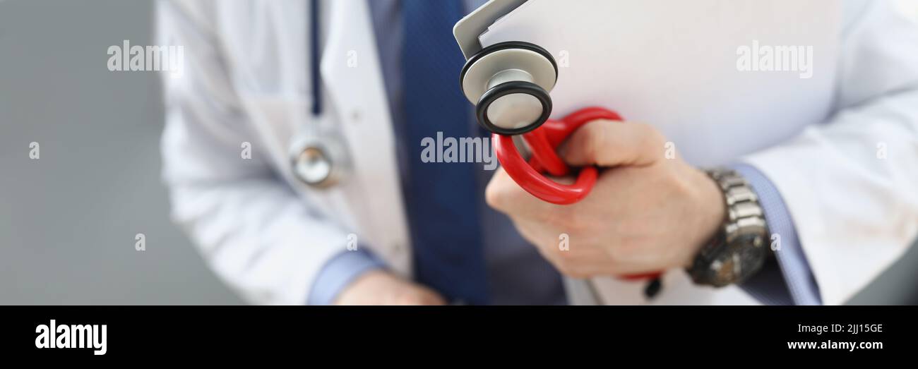 Doctor holding medical equipment red stethoscope and patient medical ...