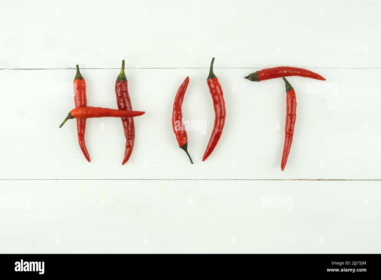 red very hot chillies spelling the word 'hot' on white background Stock ...