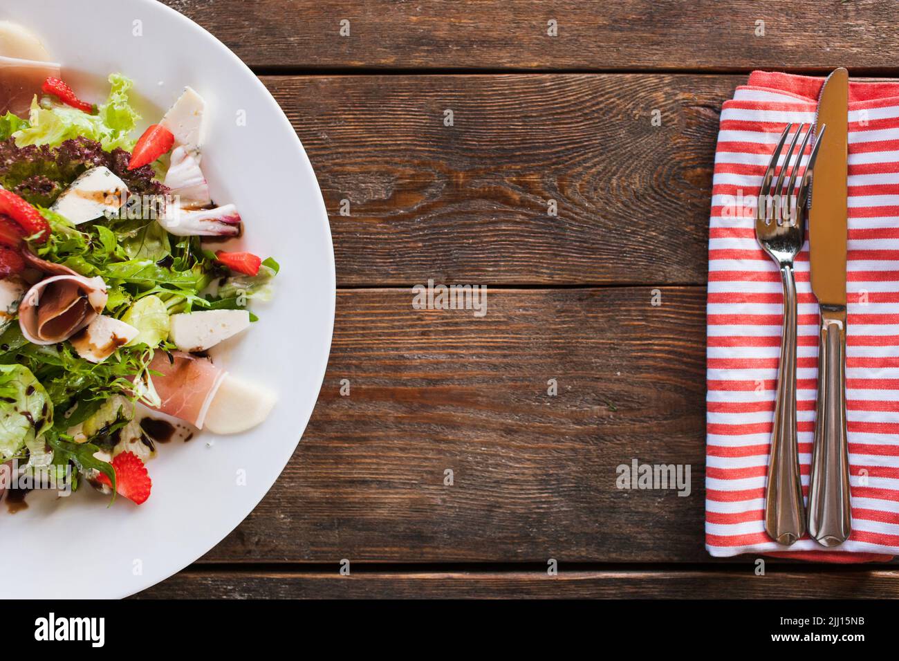 Fresh salad with parma ham serving in restaurant Stock Photo - Alamy