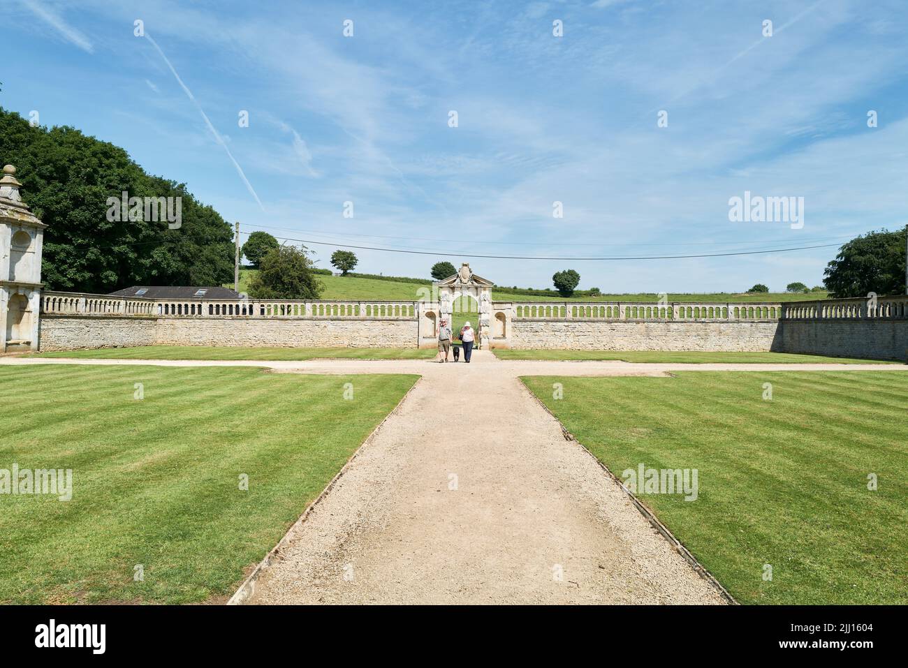 A couple enter the forecourt of an abandoned and dilapidated english ...