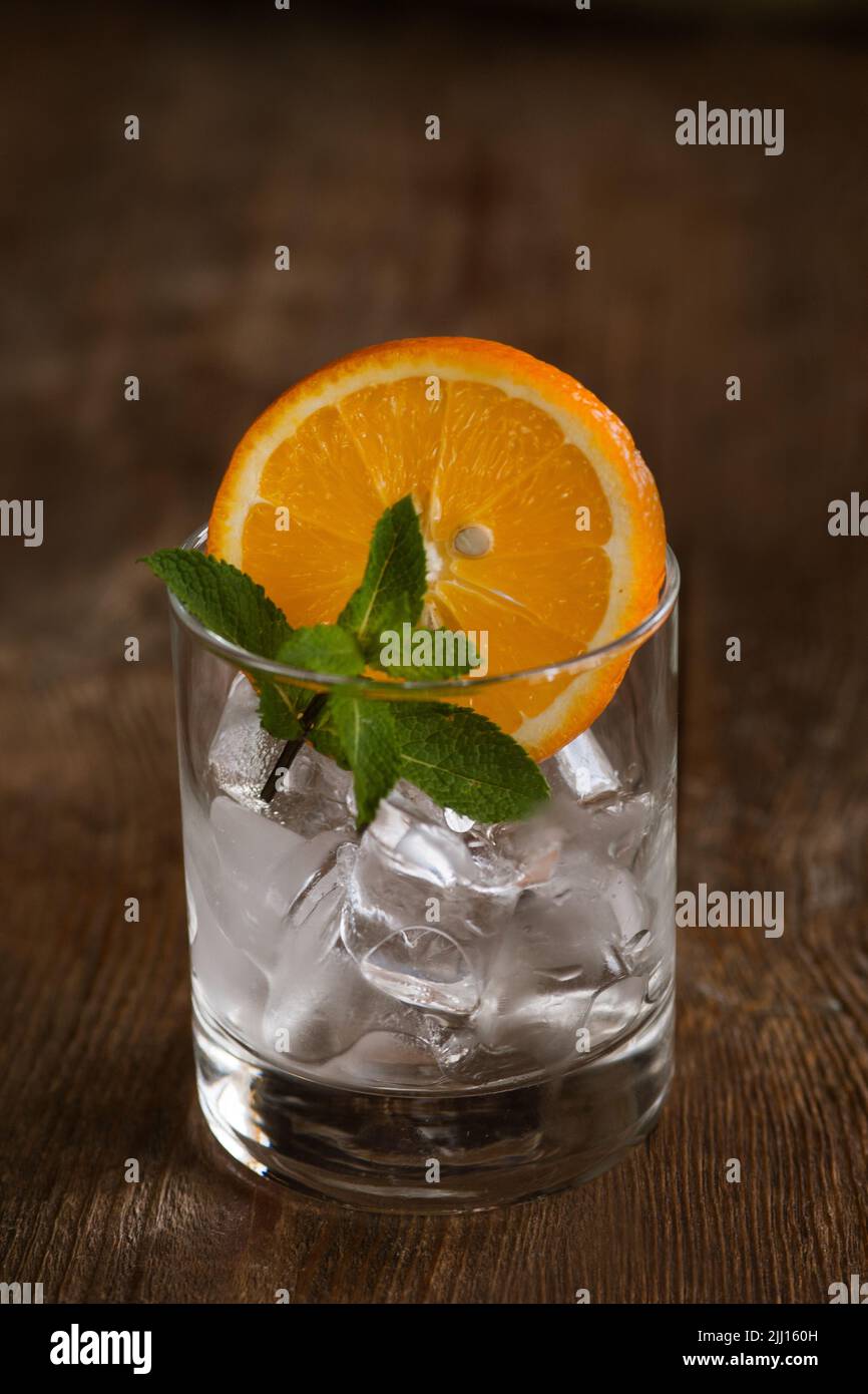 Glass of cold fresh drink with citrus slice Stock Photo - Alamy