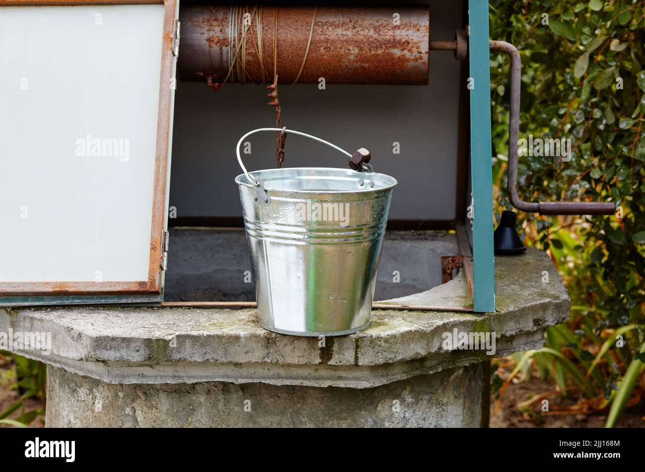 Old draw-well in European village. Retro stone water well in rural area ...