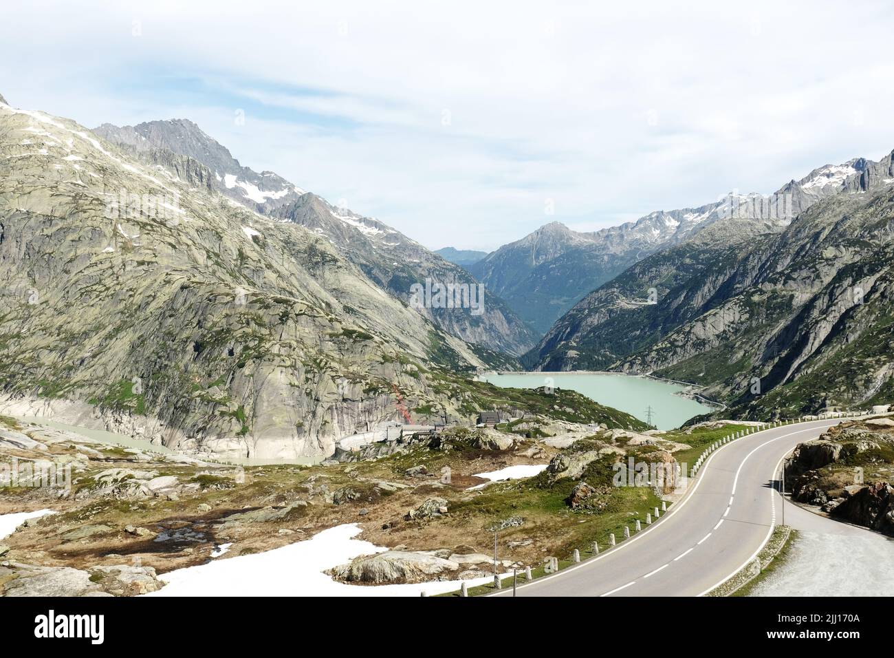 The mountain, dam, and road at Grimsel Pass in Switzerland Stock Photo ...
