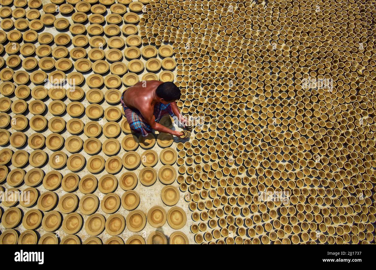 Potters spinning clay by hand in rural Bangladesh, showcasing village ...
