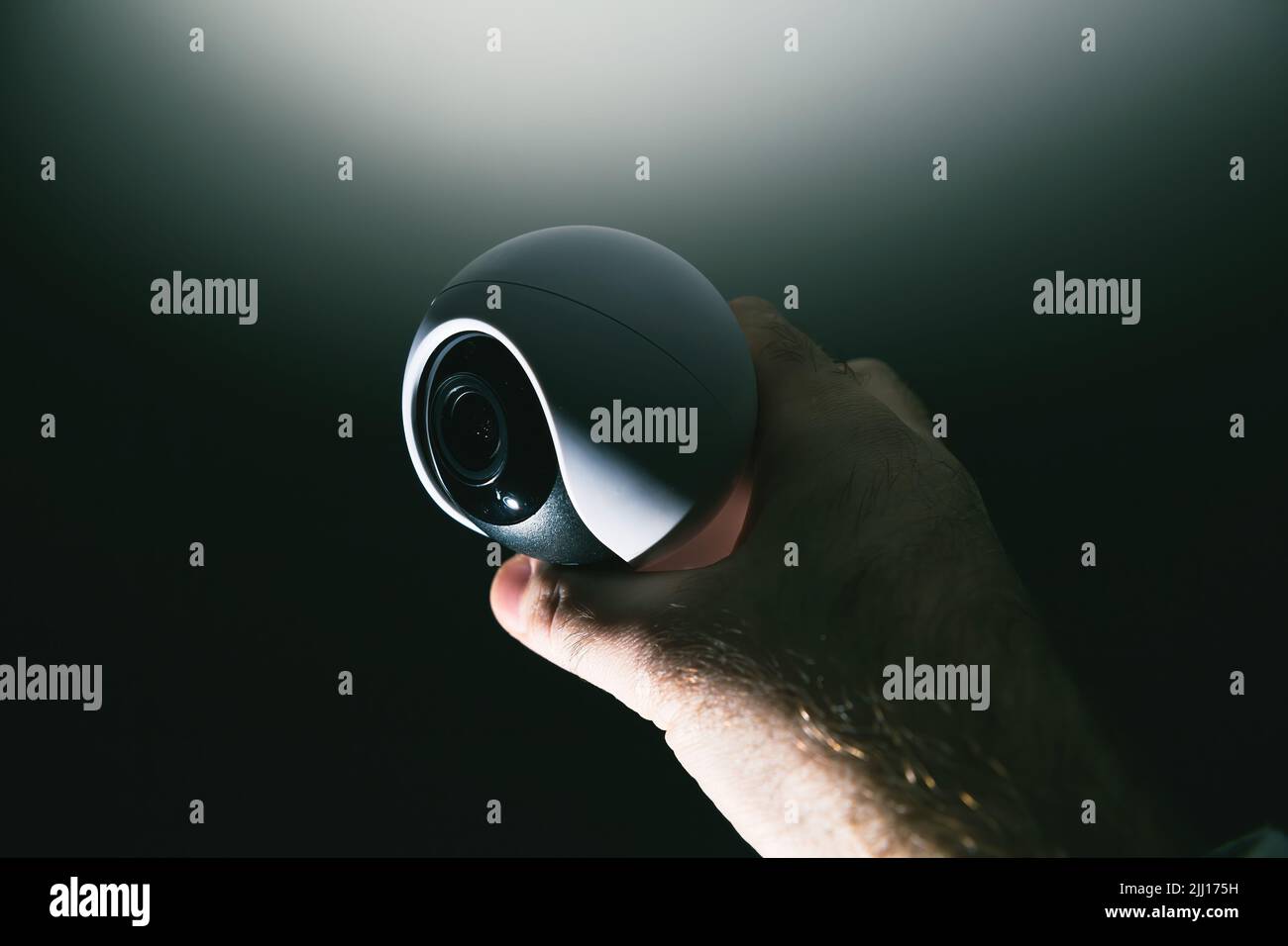Male hand holding CCTV surveillance camera in hand - spying concept 24 ...