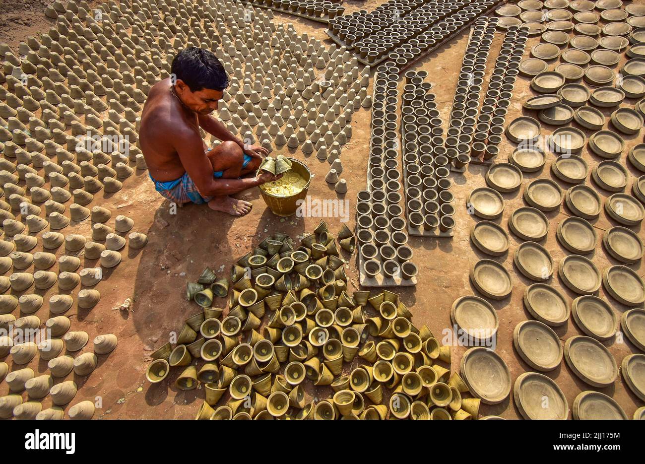 Potters spinning clay by hand in rural Bangladesh, showcasing village ...