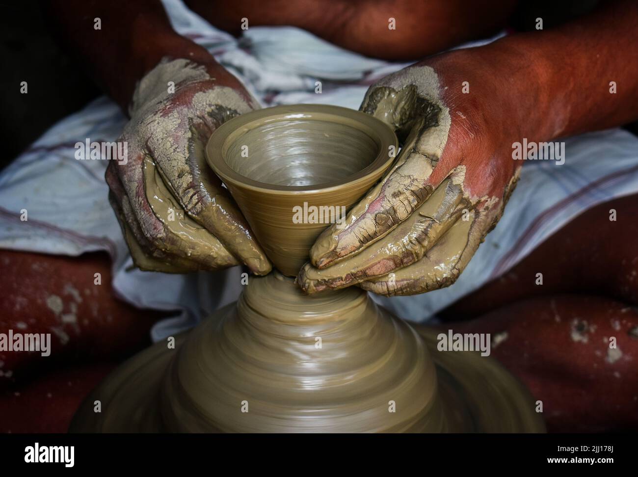 Potters spinning clay by hand in rural Bangladesh, showcasing village ...