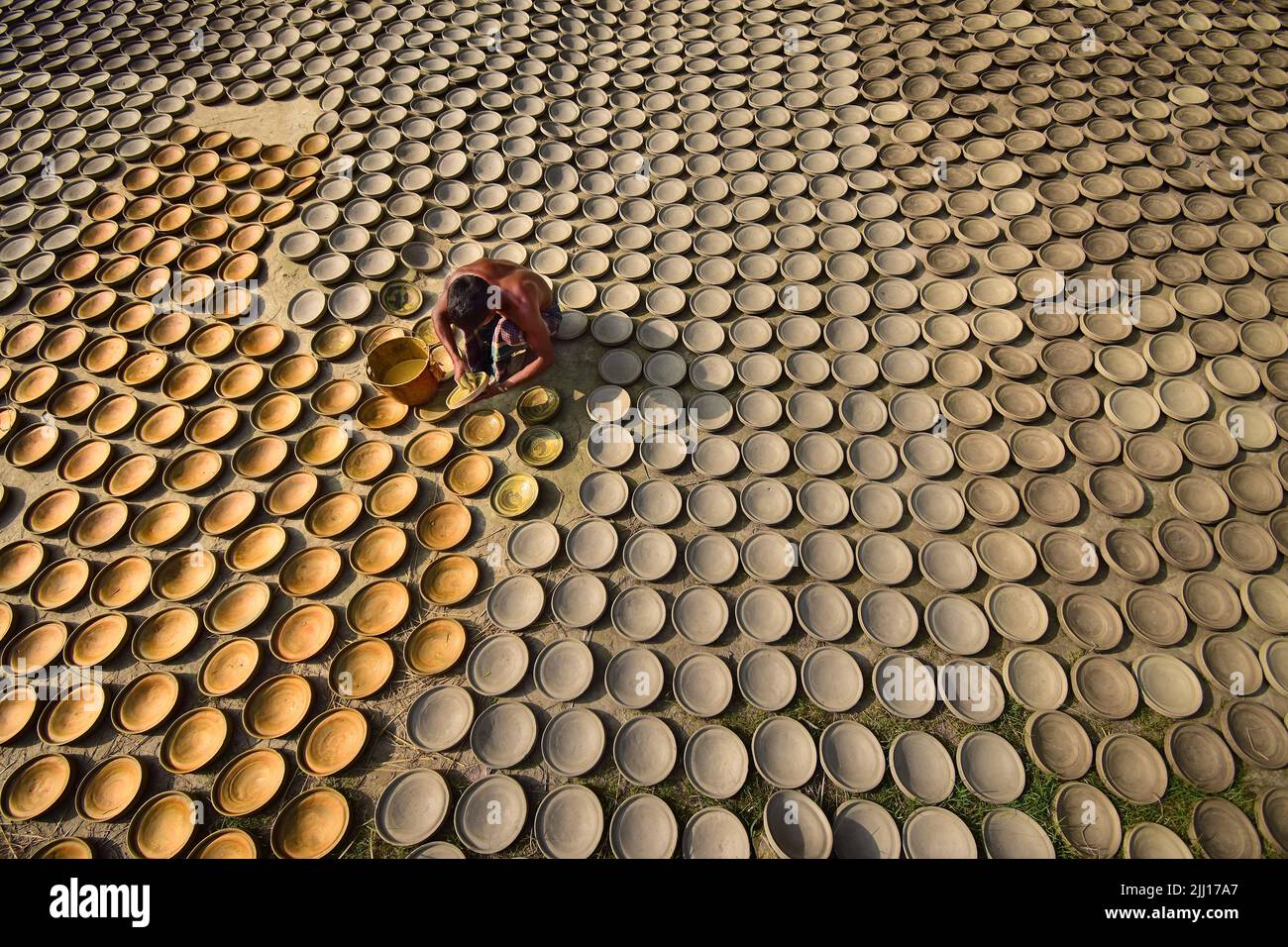 Potters spinning clay by hand in rural Bangladesh, showcasing village ...