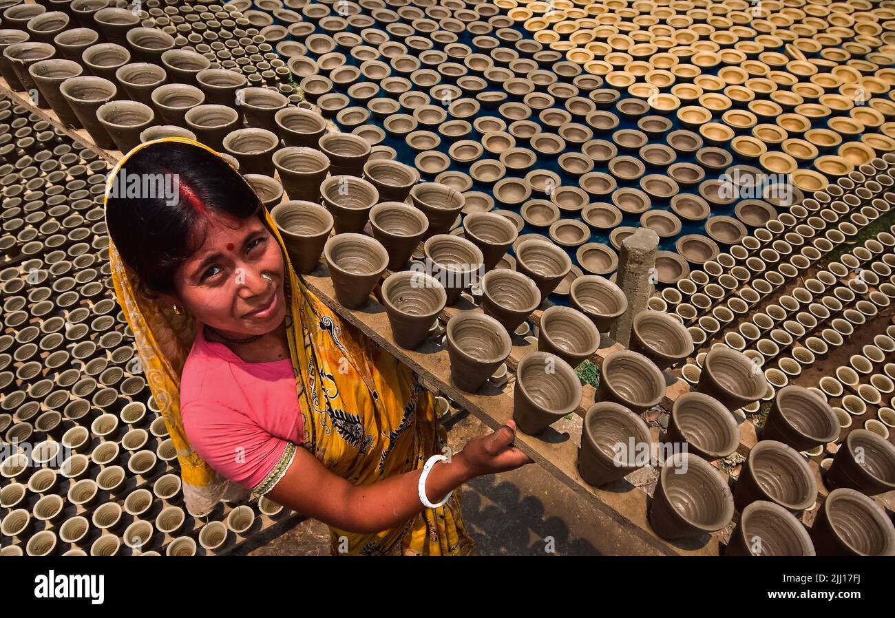 Potters spinning clay by hand in rural Bangladesh, showcasing village ...
