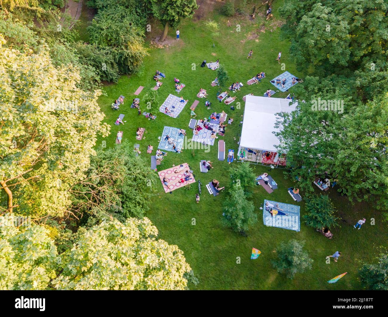 people laying down at city public park Stock Photo - Alamy